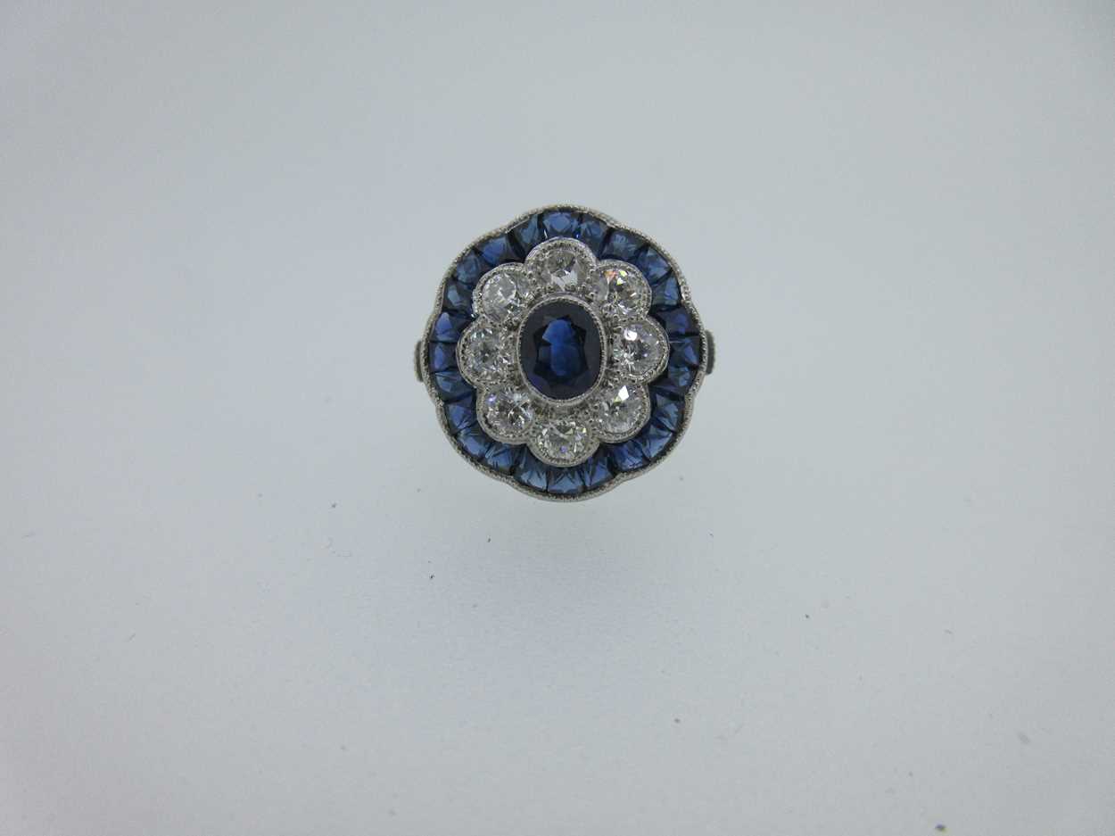 Lot 162 - A sapphire and diamond flower head ring,